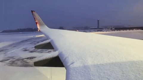 A plane's wing with a little snow. : gifs